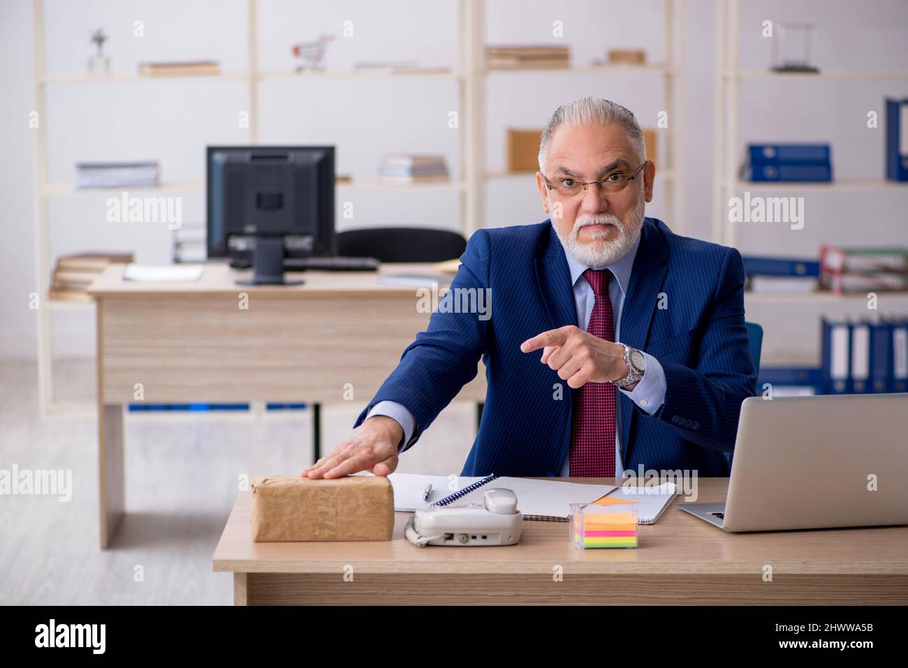 Old businessman employee ordering box via Internet Stock Photo - Alamy