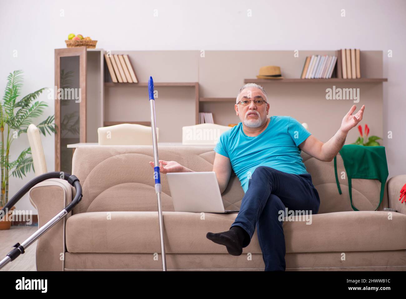 Aged man cleaning the house Stock Photo - Alamy