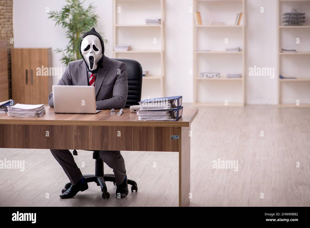 Devil businessman employee working in the office Stock Photo - Alamy