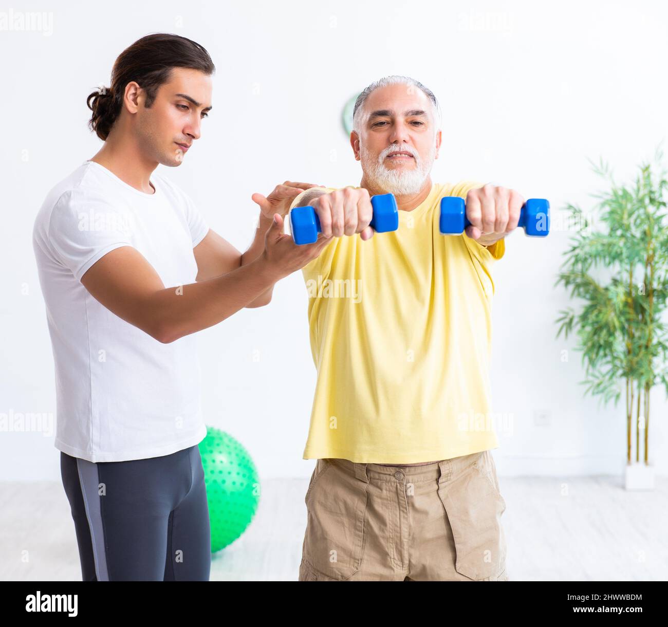 The old man doing exercises indoors Stock Photo - Alamy