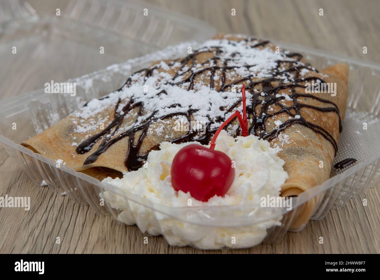 Delicious sweet crepe pancake drizzled with hot fudge, sprinkled with ...