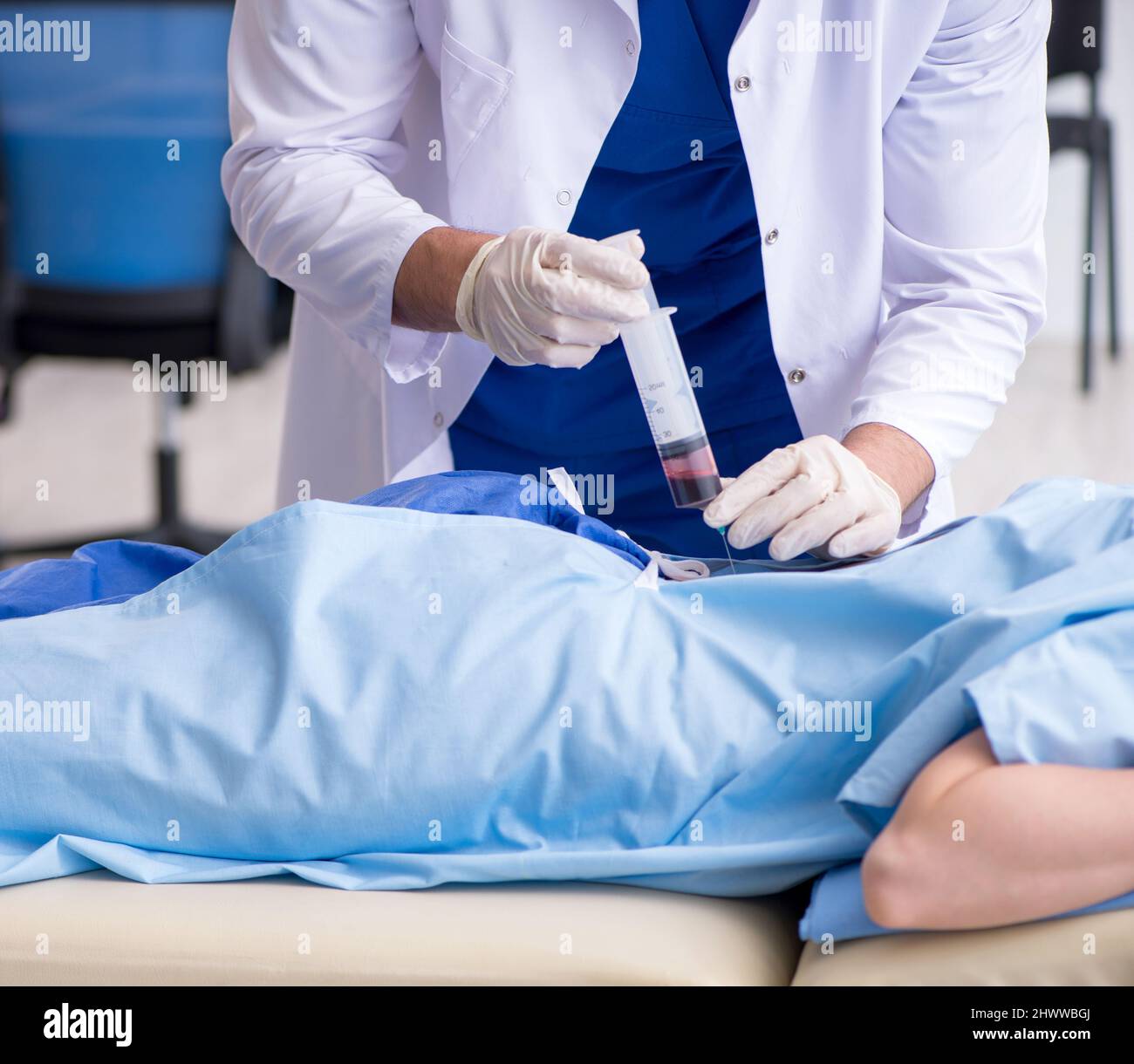 The female patient getting an injection in the clinic Stock Photo - Alamy