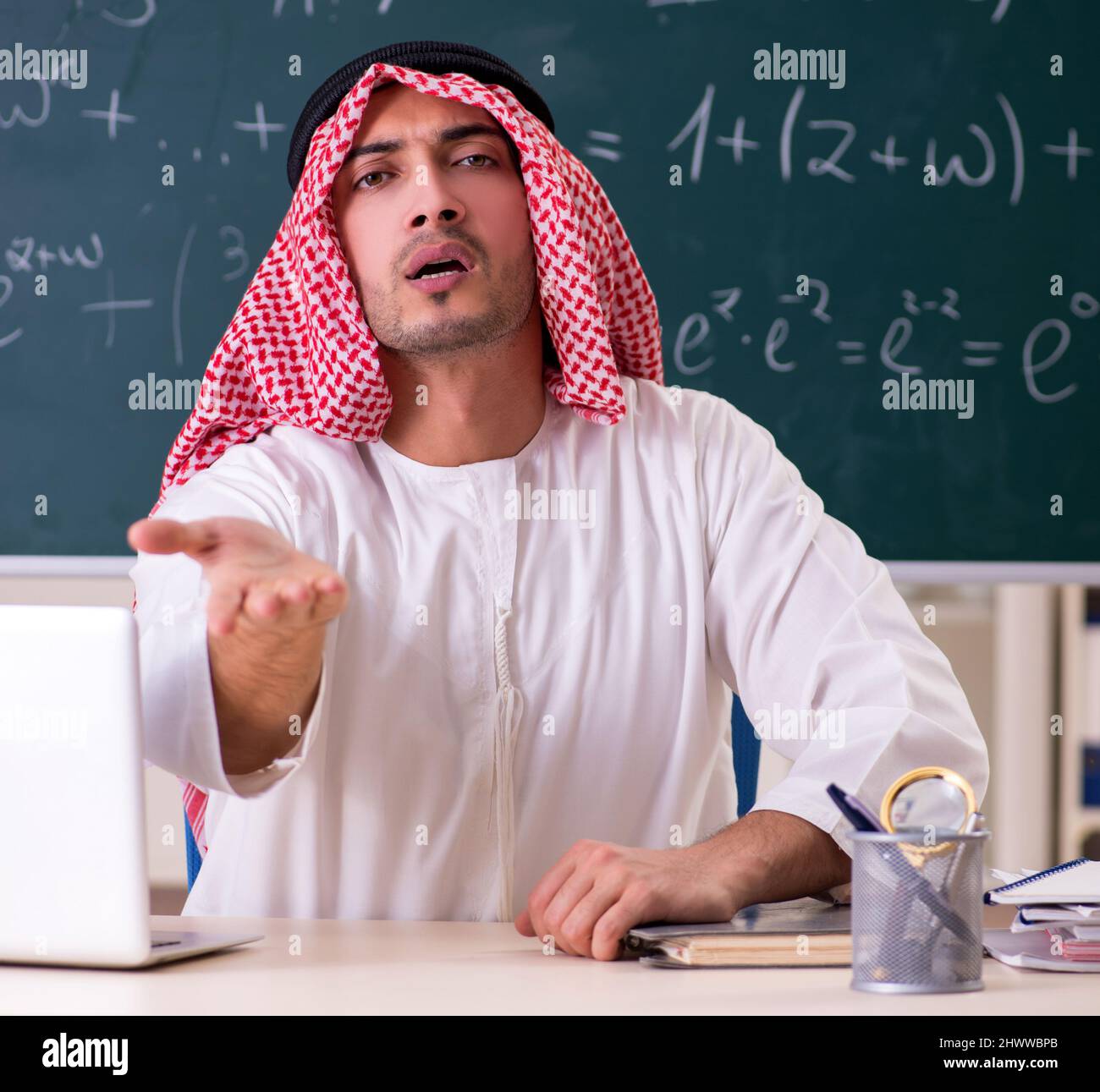 Arab teacher in front of chalkboard Stock Photo - Alamy