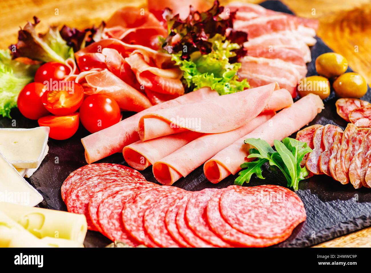 Assortment of salami prosciutto meats and sausages, olives and spices ...