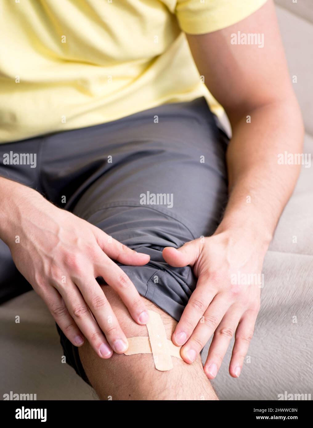 The young man at home after injury Stock Photo - Alamy