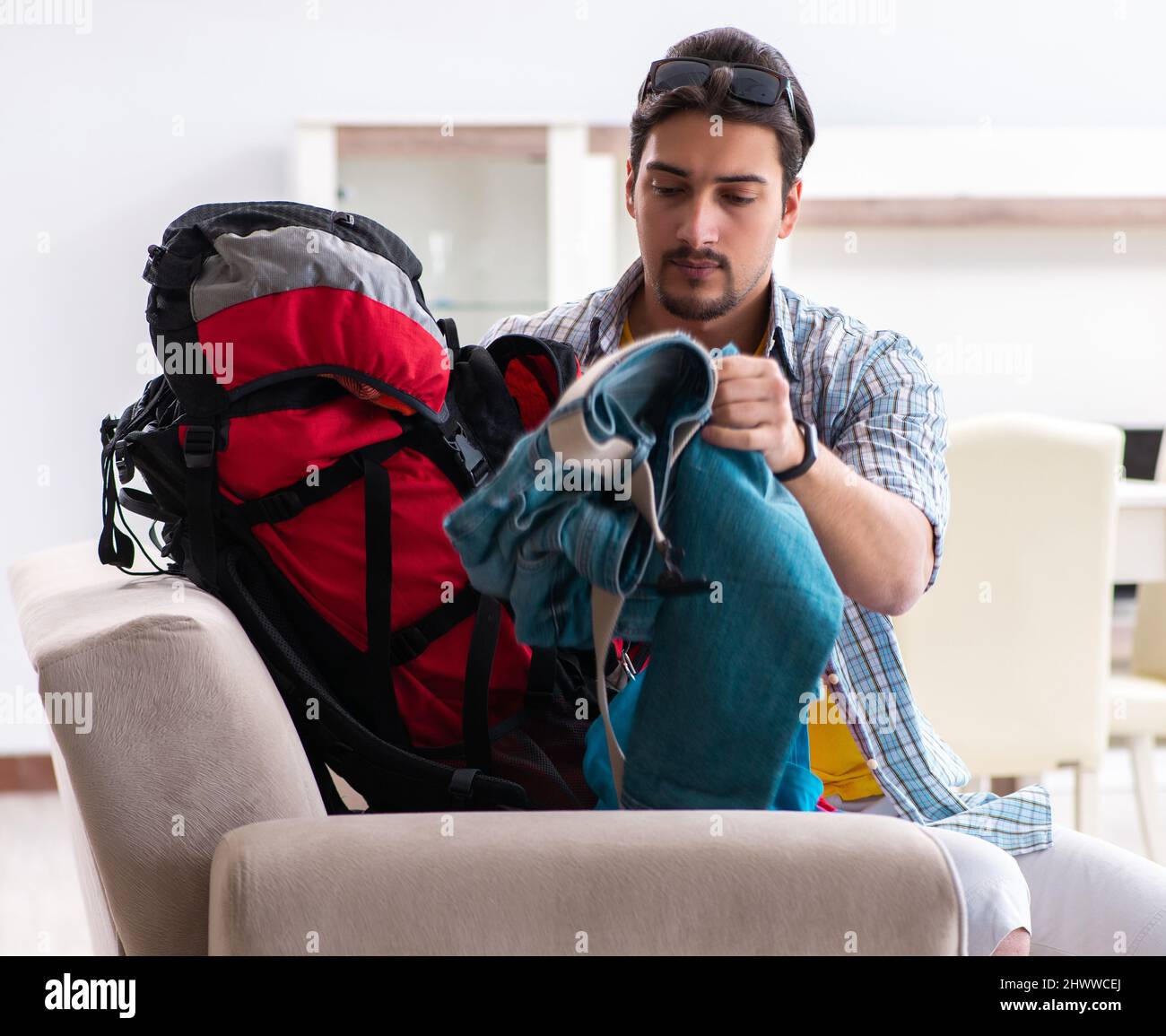 The backpacker packing for his trip Stock Photo - Alamy