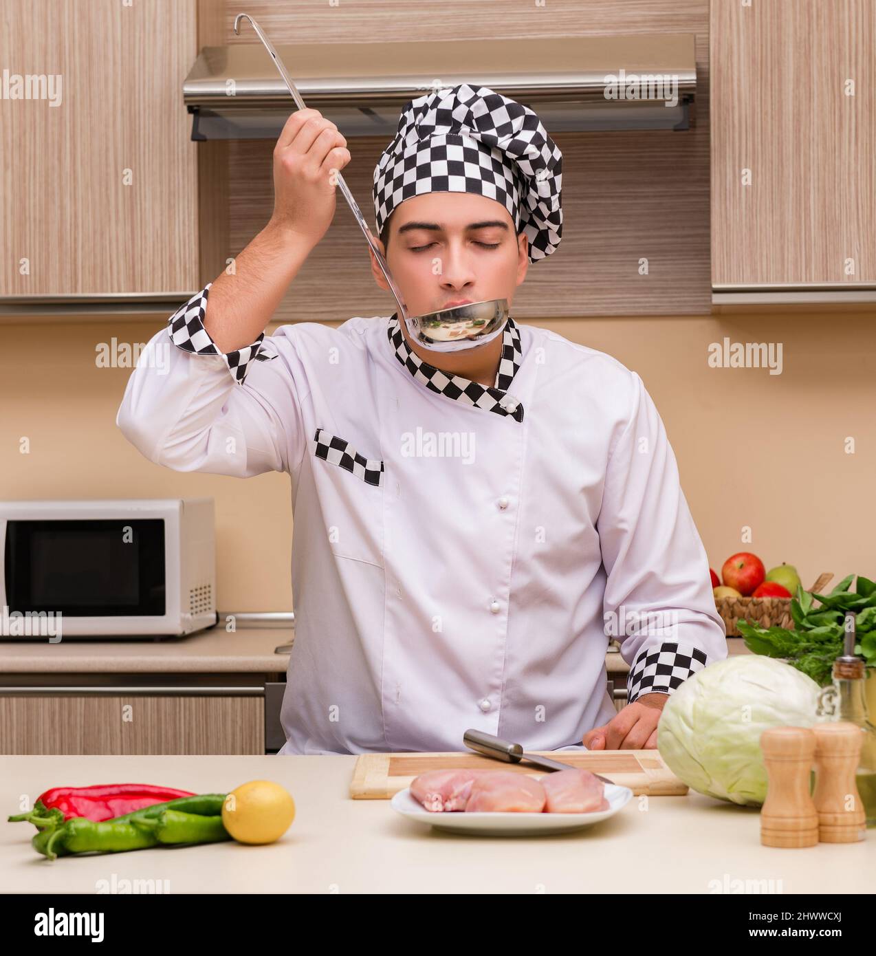 The young chef working in the kitchen Stock Photo - Alamy