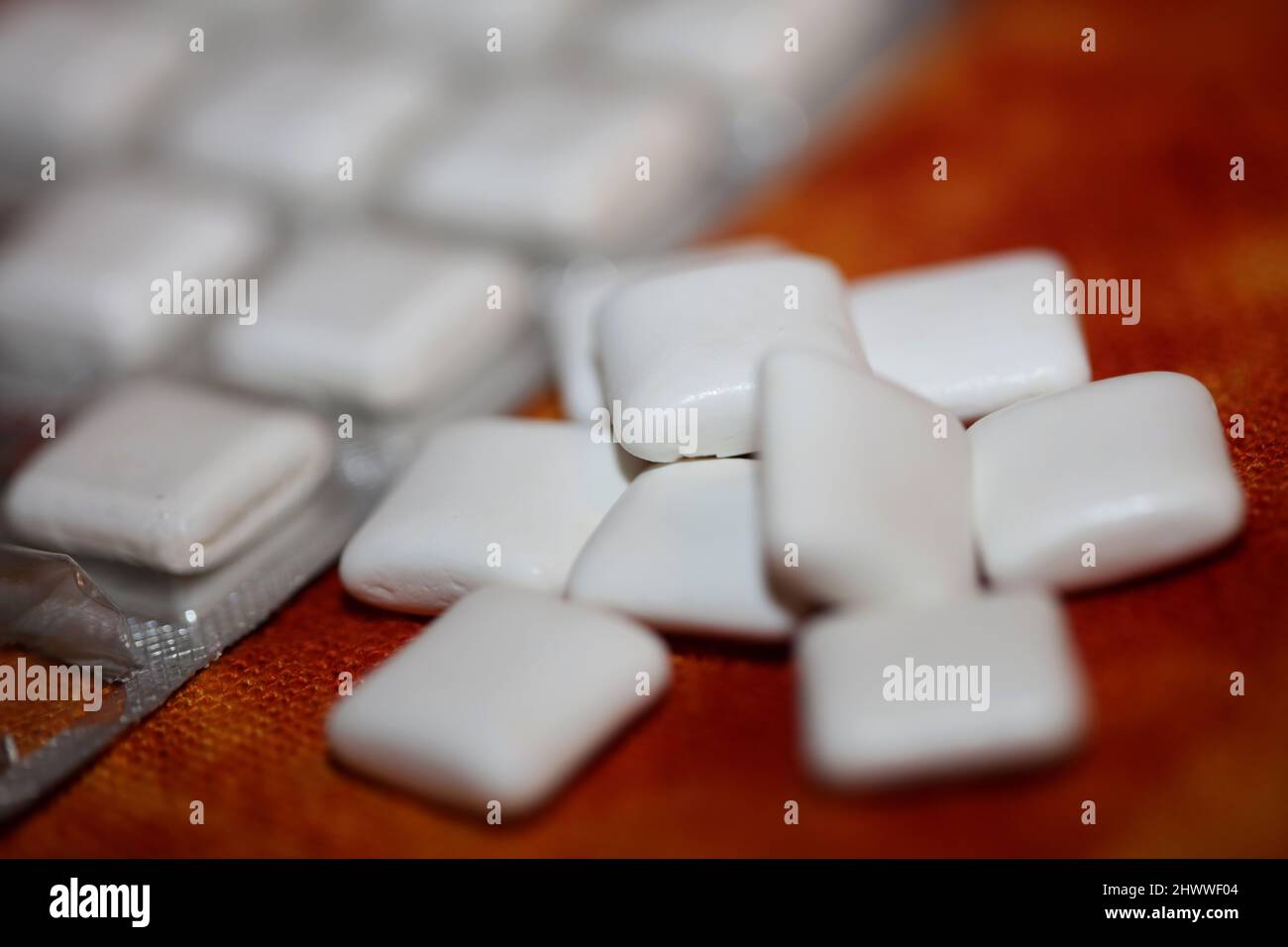 White nicotine square bubble gums close up smoking mania background ...