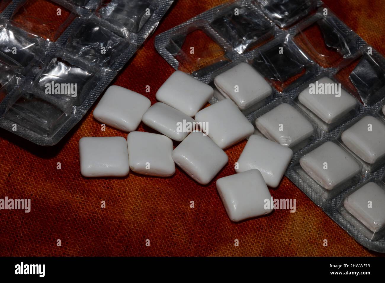 White nicotine square bubble gums close up smoking mania background ...