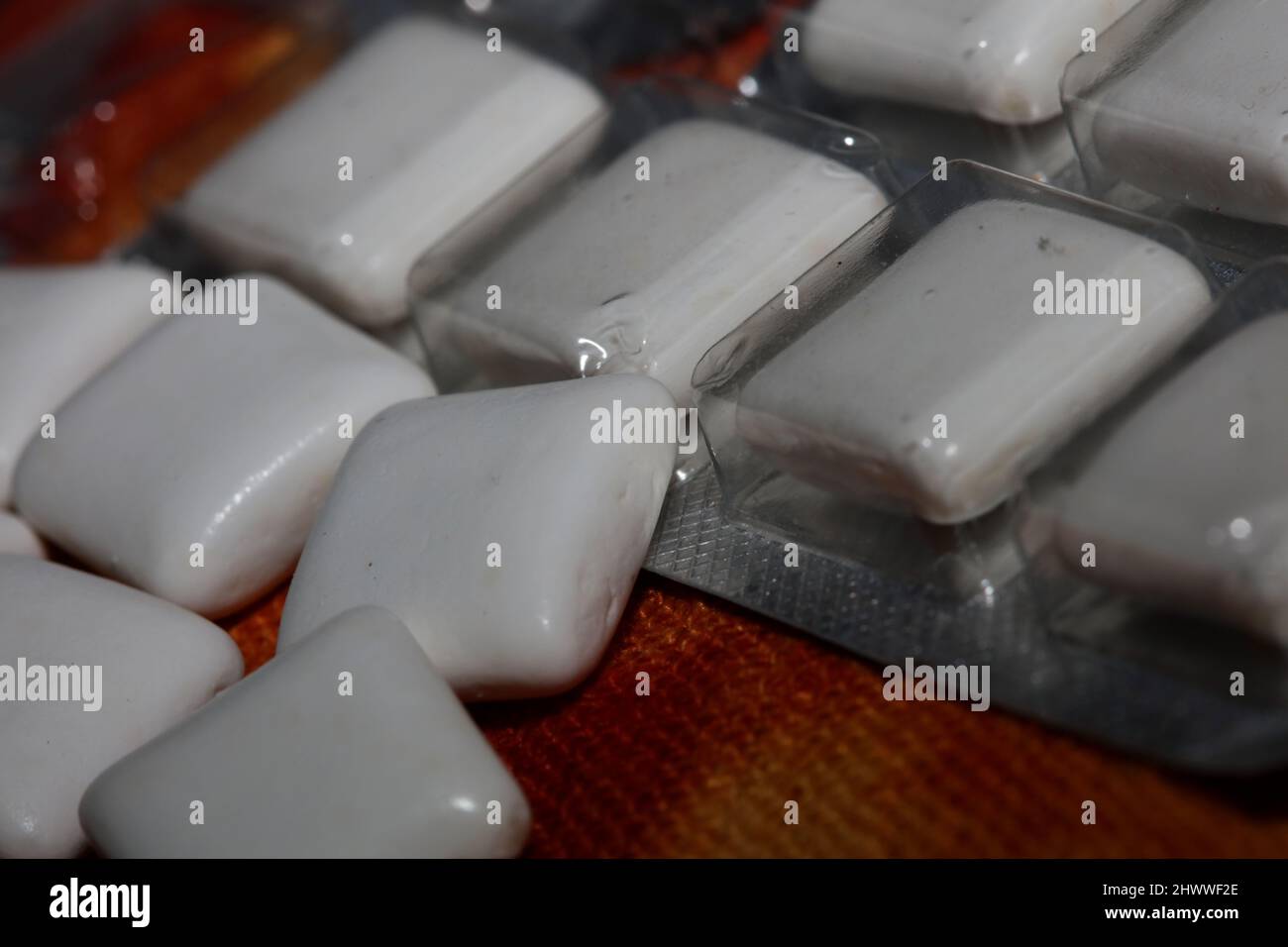 White nicotine square bubble gums close up smoking mania background ...