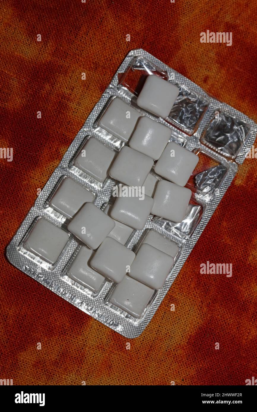 White nicotine square bubble gums close up smoking mania background ...
