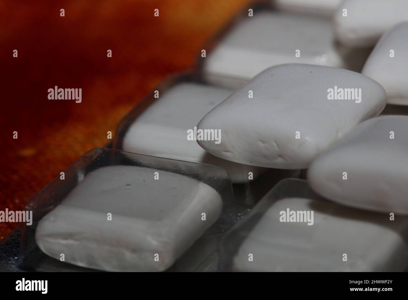 White nicotine square bubble gums close up smoking mania background ...