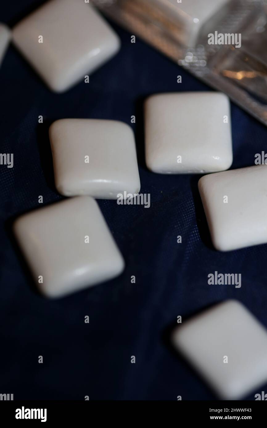 White nicotine square bubble gums close up smoking mania background ...