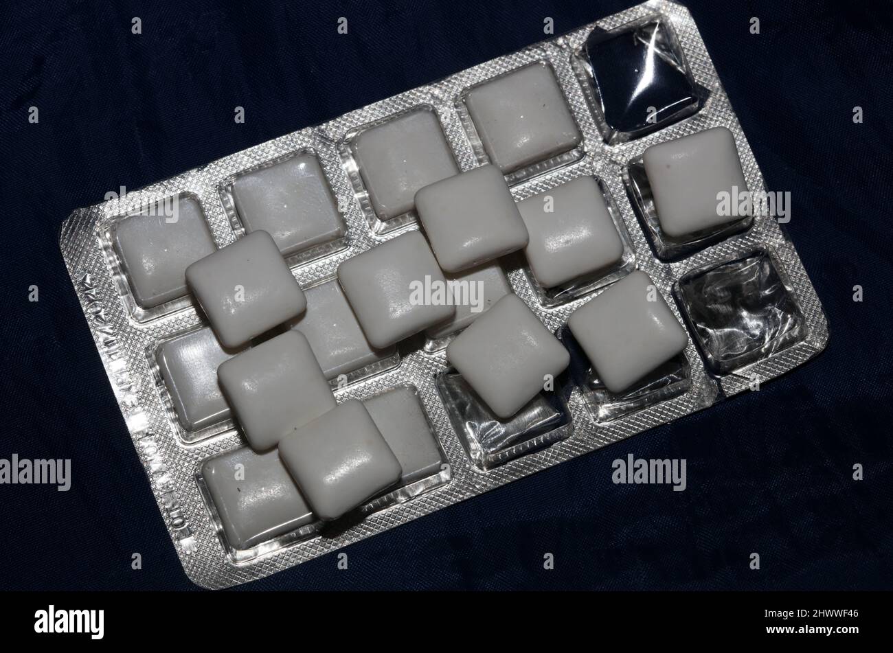 White nicotine square bubble gums close up smoking mania background ...