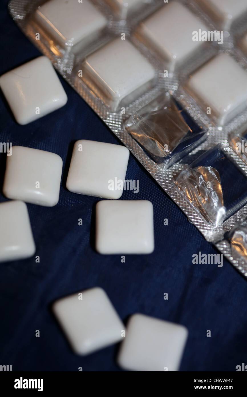 White nicotine square bubble gums close up smoking mania background ...