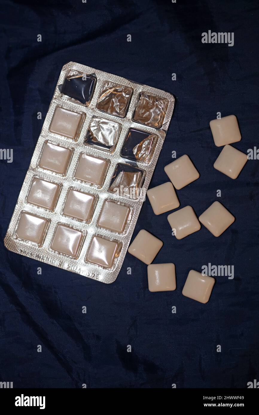White nicotine square bubble gums close up smoking mania background ...