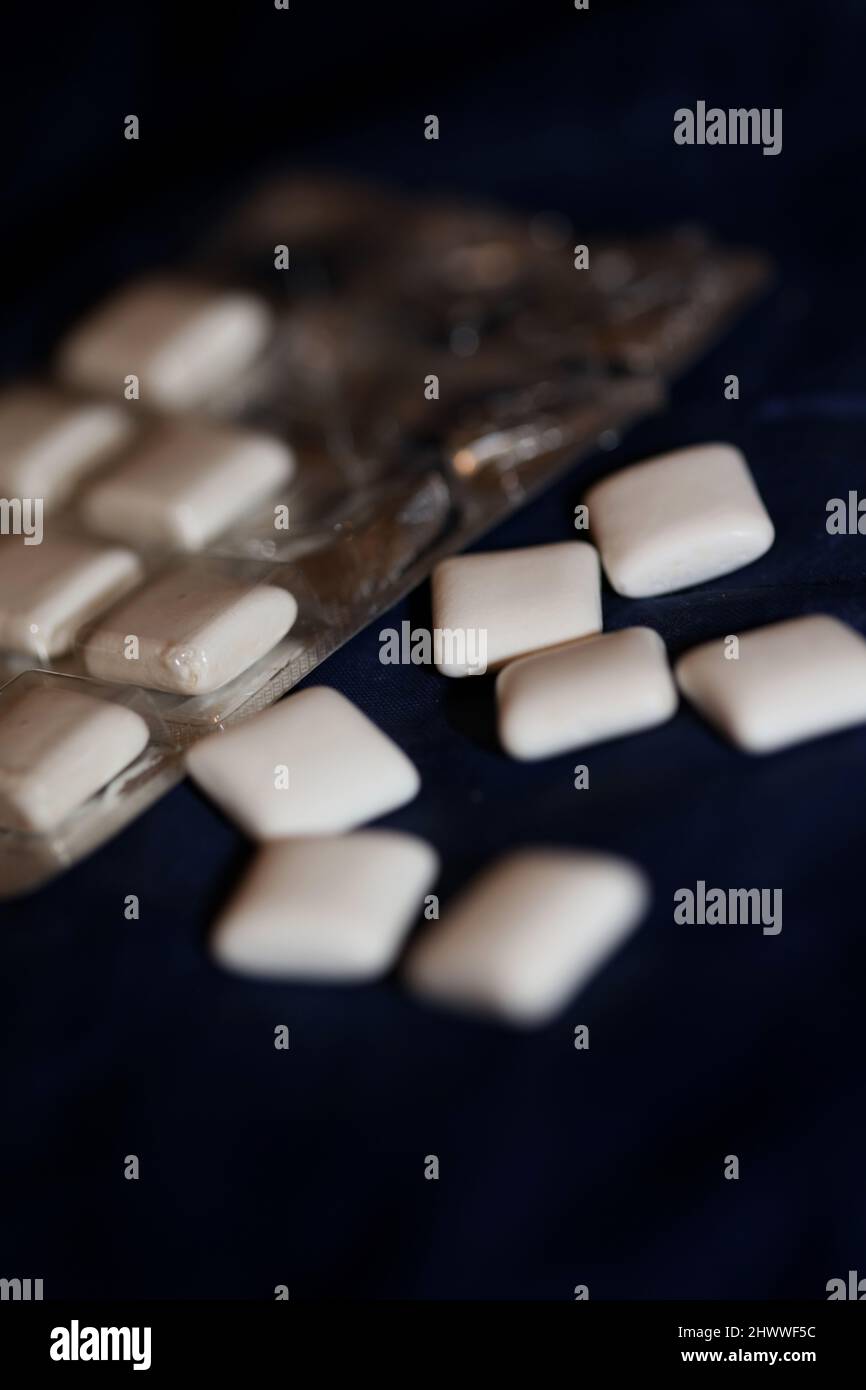 White nicotine square bubble gums close up smoking mania background ...