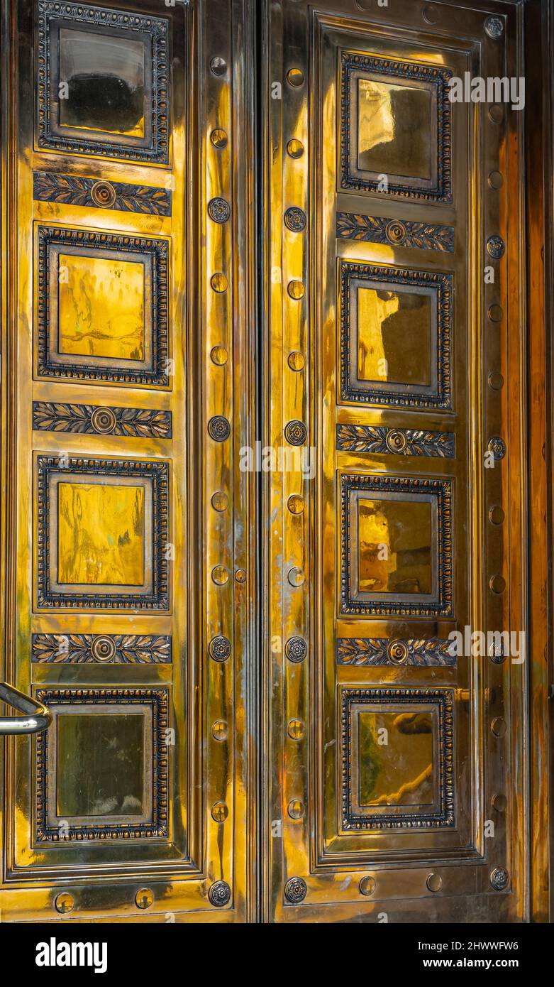 The golden ornamental door details. Close up of an old gold color doors ...