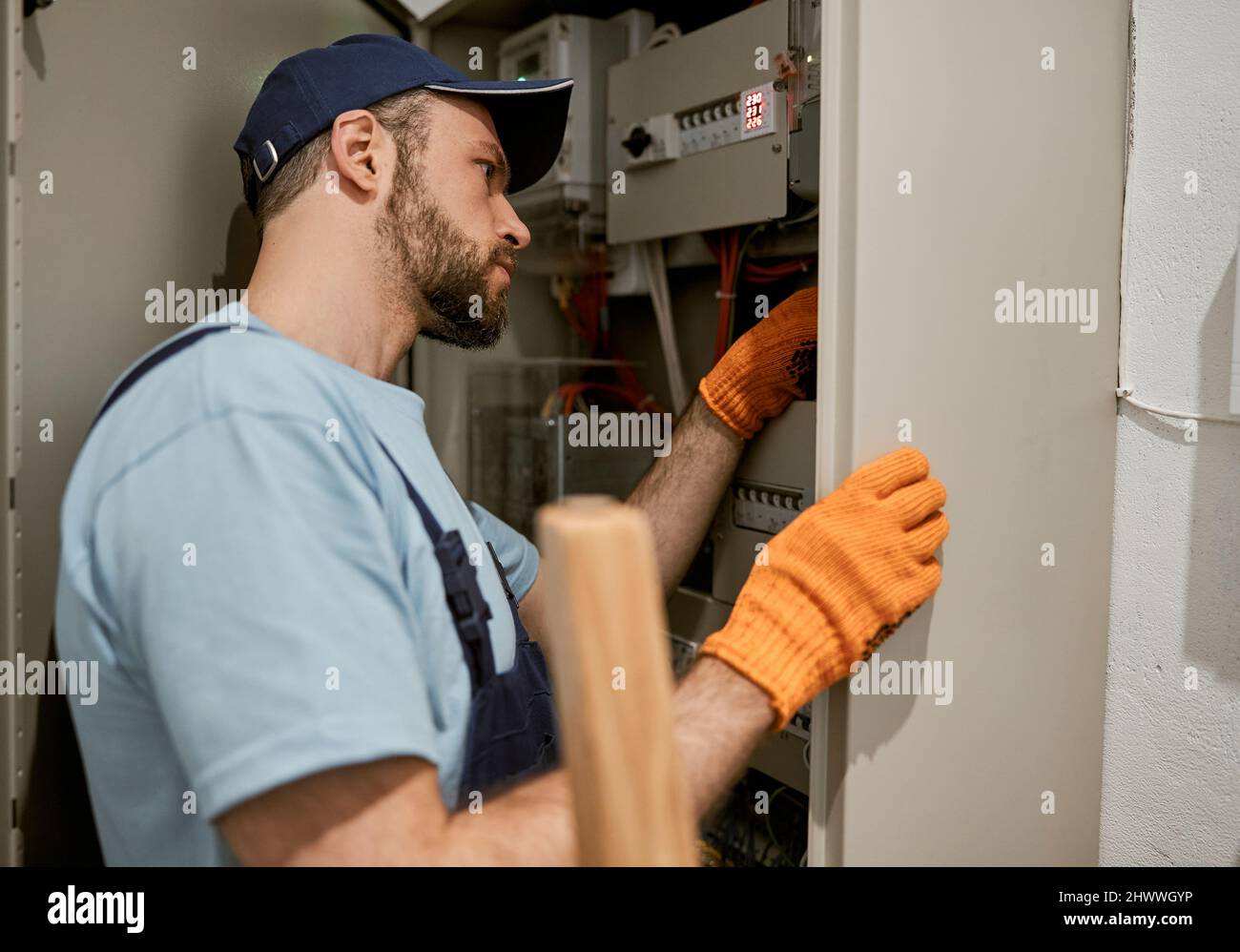 Male electrician checking electrical panel in house Stock Photo - Alamy