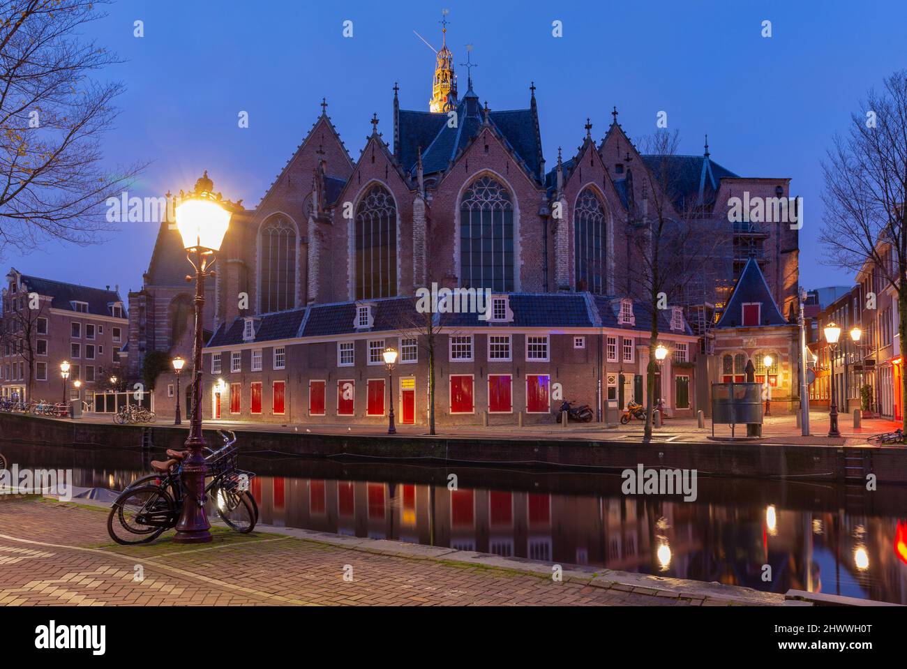 The old medieval church Oude Kerk in the red light district at dawn ...