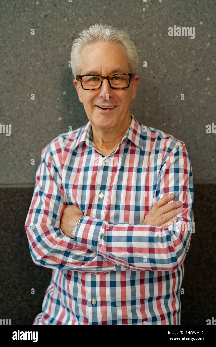 Handsome gray hair man posing with arms crossed Stock Photo - Alamy