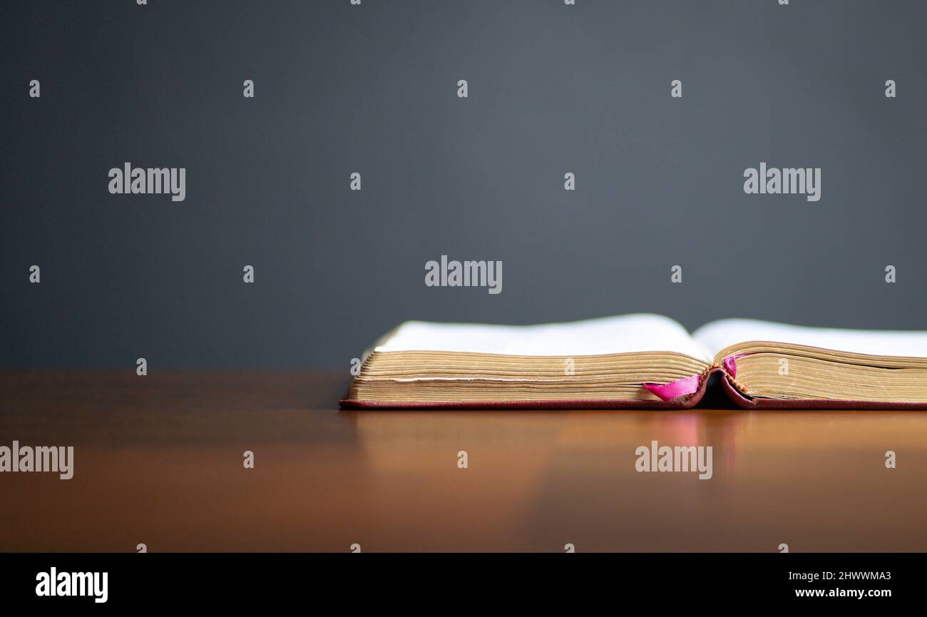 Open Holy Bible on wood table, with copy space Stock Photo - Alamy
