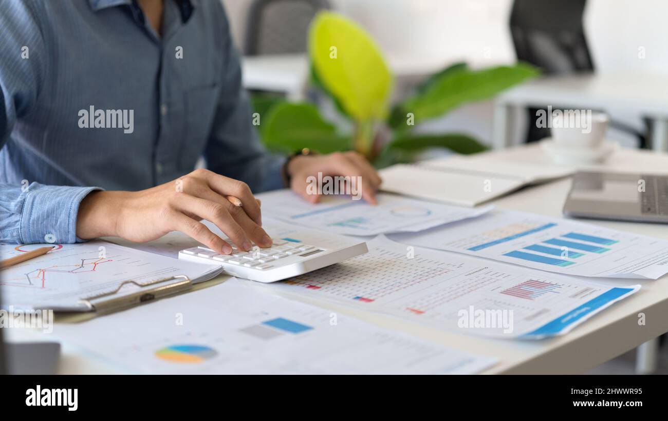 Cropped, Businessman or male accountant using calculator and working on ...