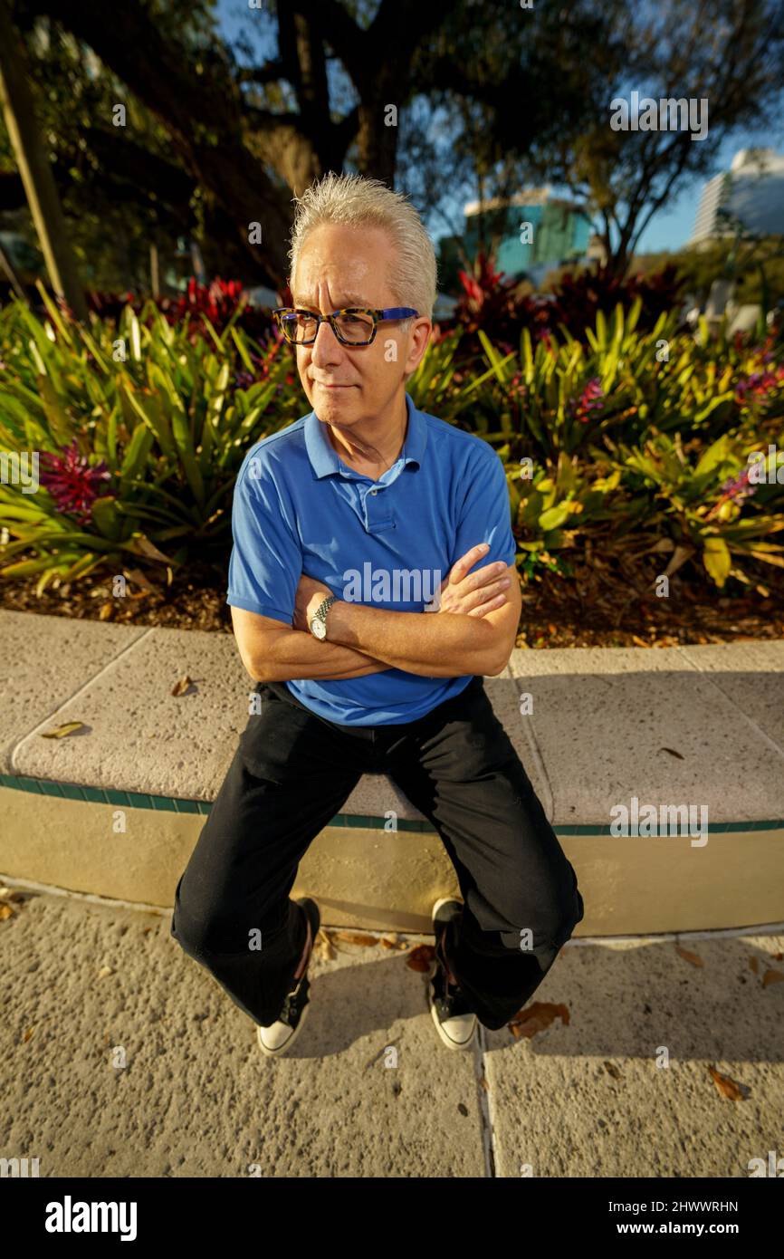 Fisheye wide angle photo of a man sitting with arms crossed Stock Photo ...