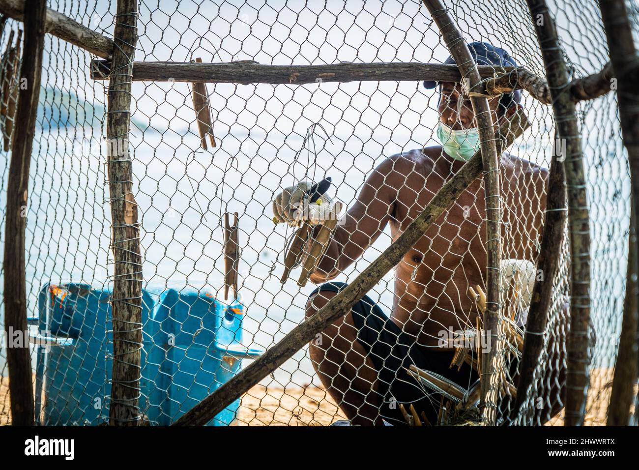 Phuket, Thailand. 08th Mar, 2022. A fisherman builds a large trap at ...