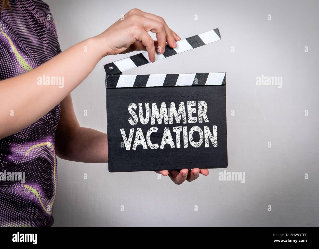 SUMMER VACATION. Female hands holding movie clapper Stock Photo - Alamy