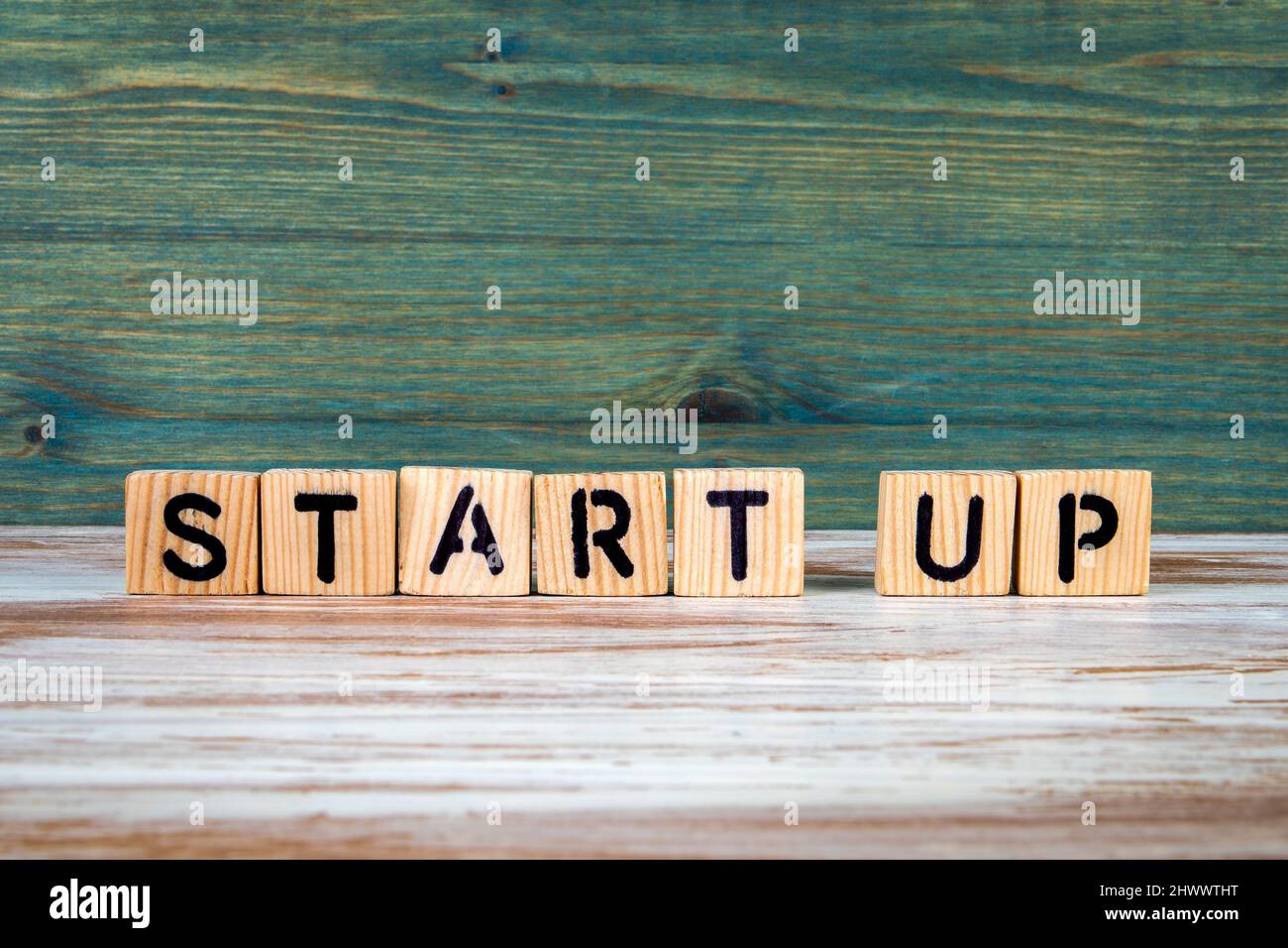 Start Up. Text from wooden blocks on a white and green background Stock ...