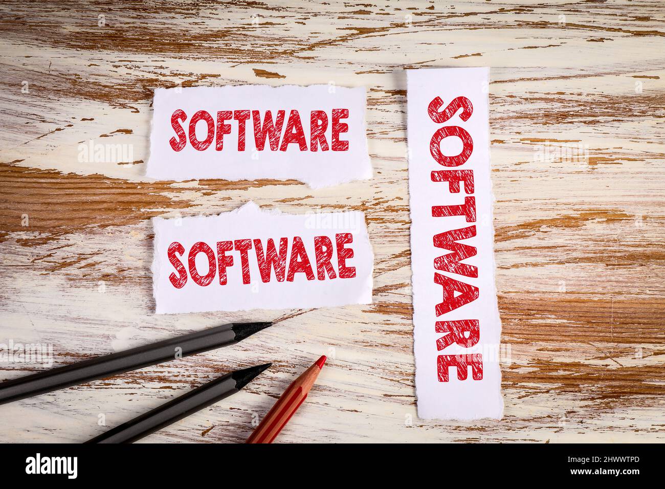 SOFTWARE. Text on sheets of paper. White painted wooden background ...