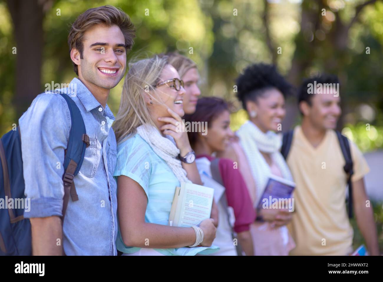 Excited about college. A group of students standing in a line on campus ...