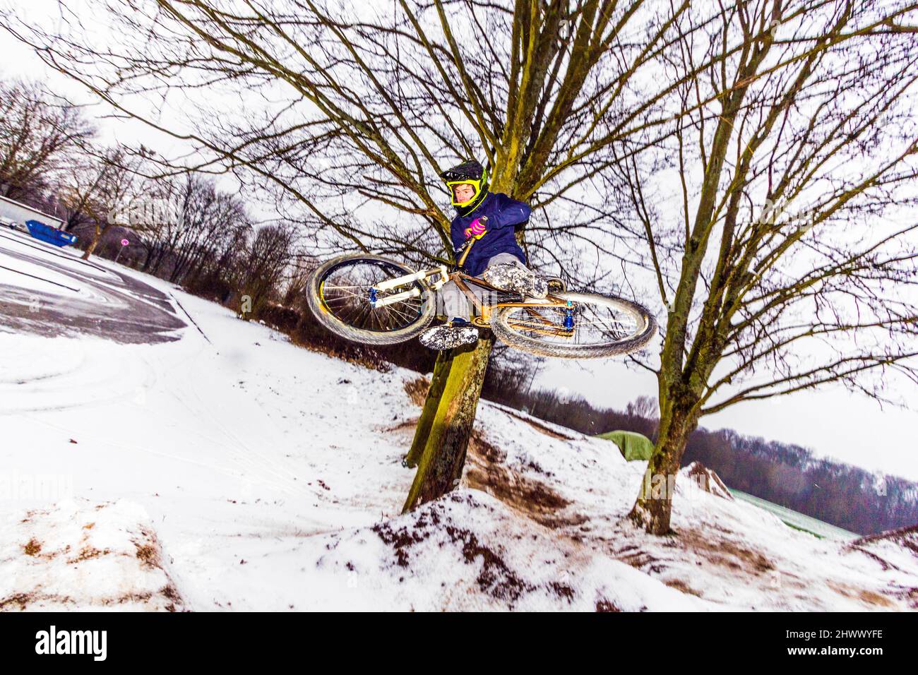 boy jumping with his bike over a ramp in snow Stock Photo - Alamy