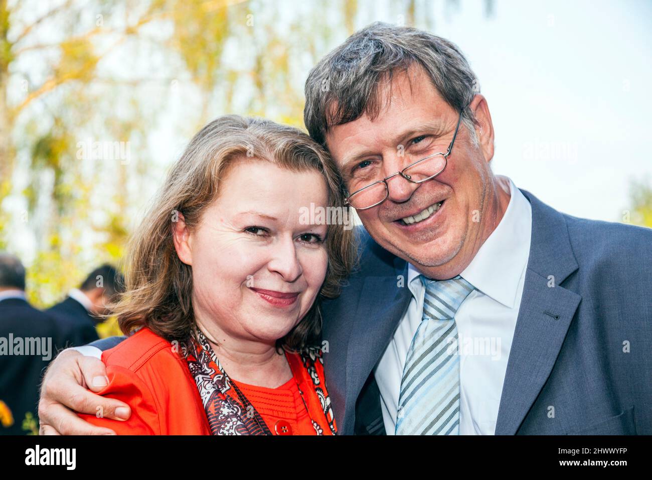 happy couple standing arm in arm Stock Photo - Alamy