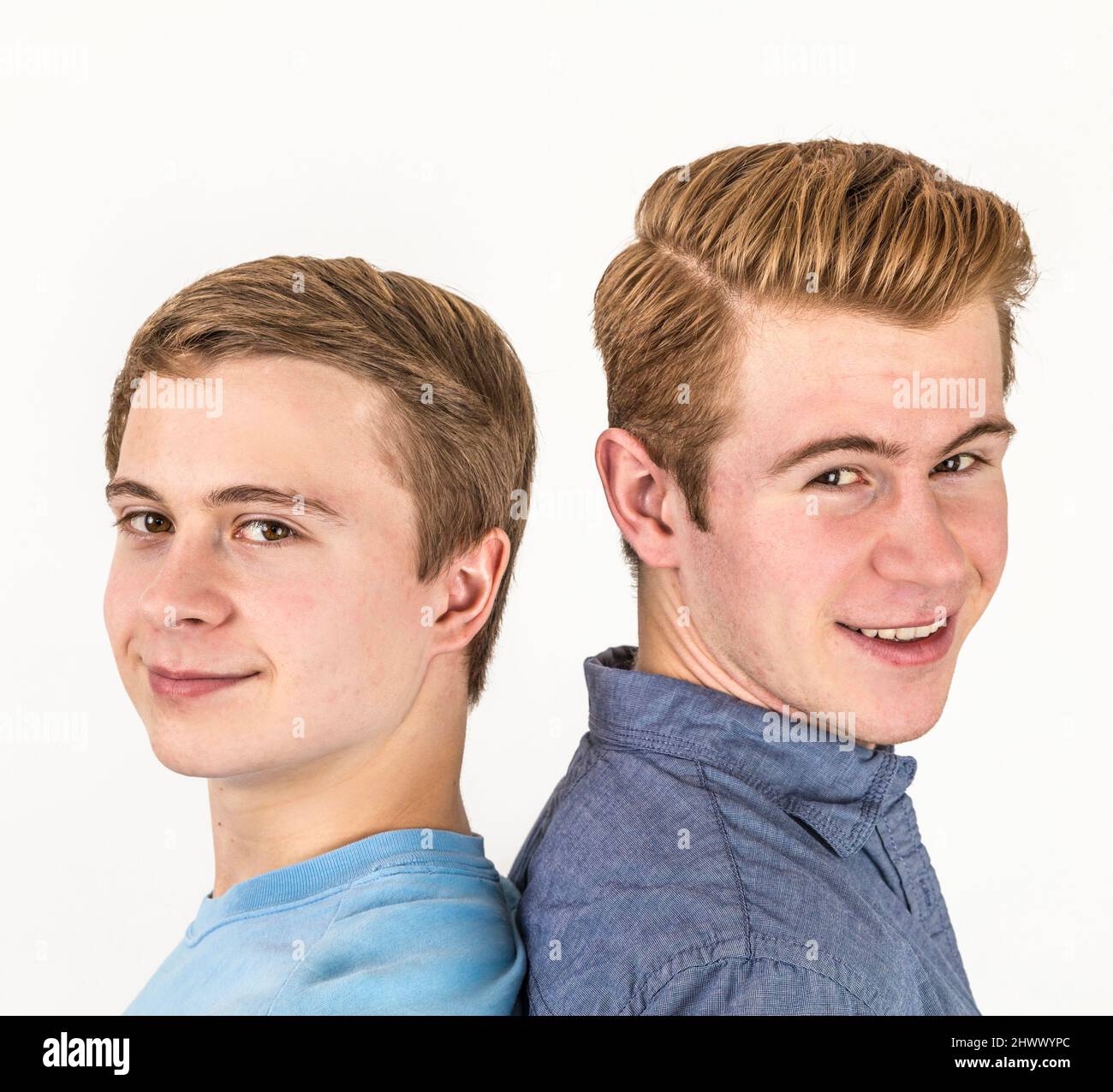 portrait of handsome brothers posing in studio Stock Photo - Alamy