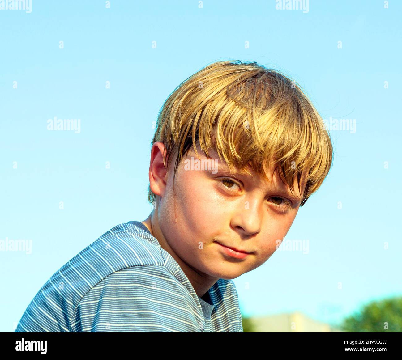 boy with sweating face under blue sky Stock Photo - Alamy