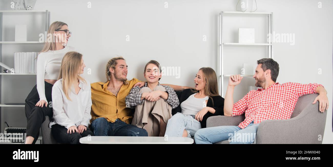 Group of young people sitting on sofa and talking at home. Young ...