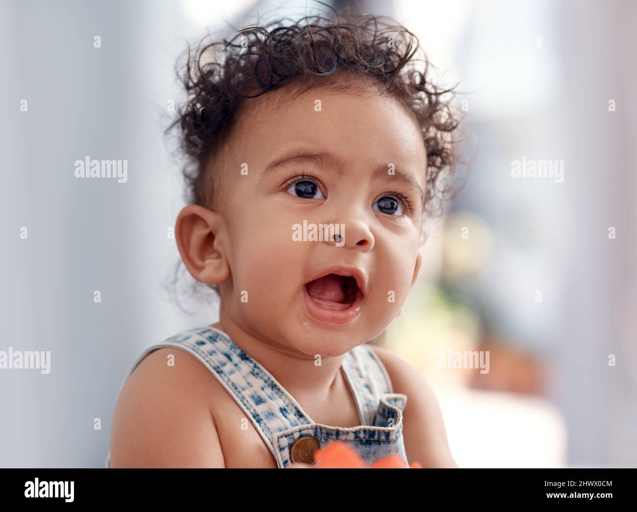 Wait, what. Shot of an adorable baby boy at home Stock Photo - Alamy