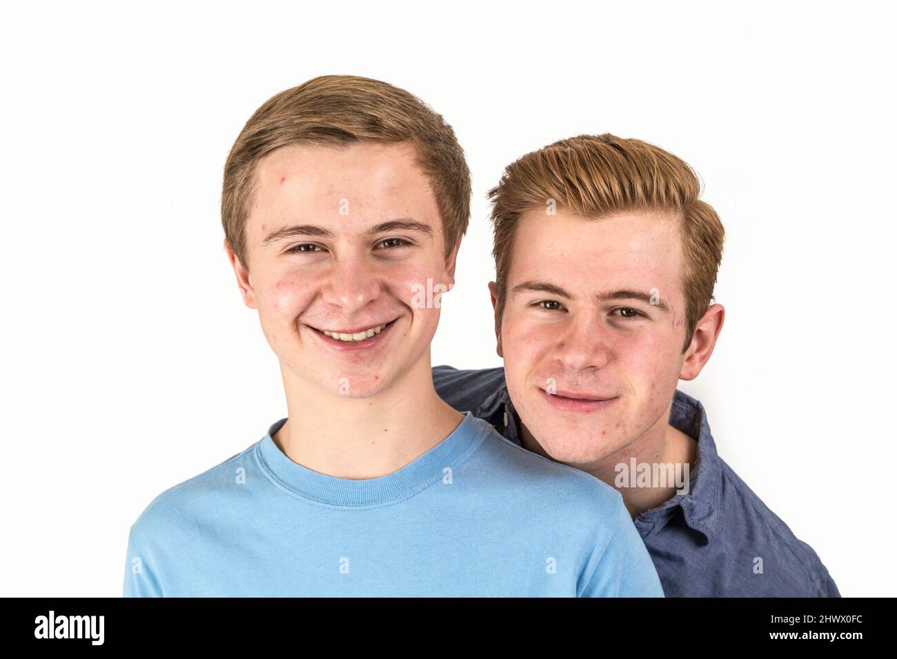portrait of handsome brothers posing in studio Stock Photo - Alamy