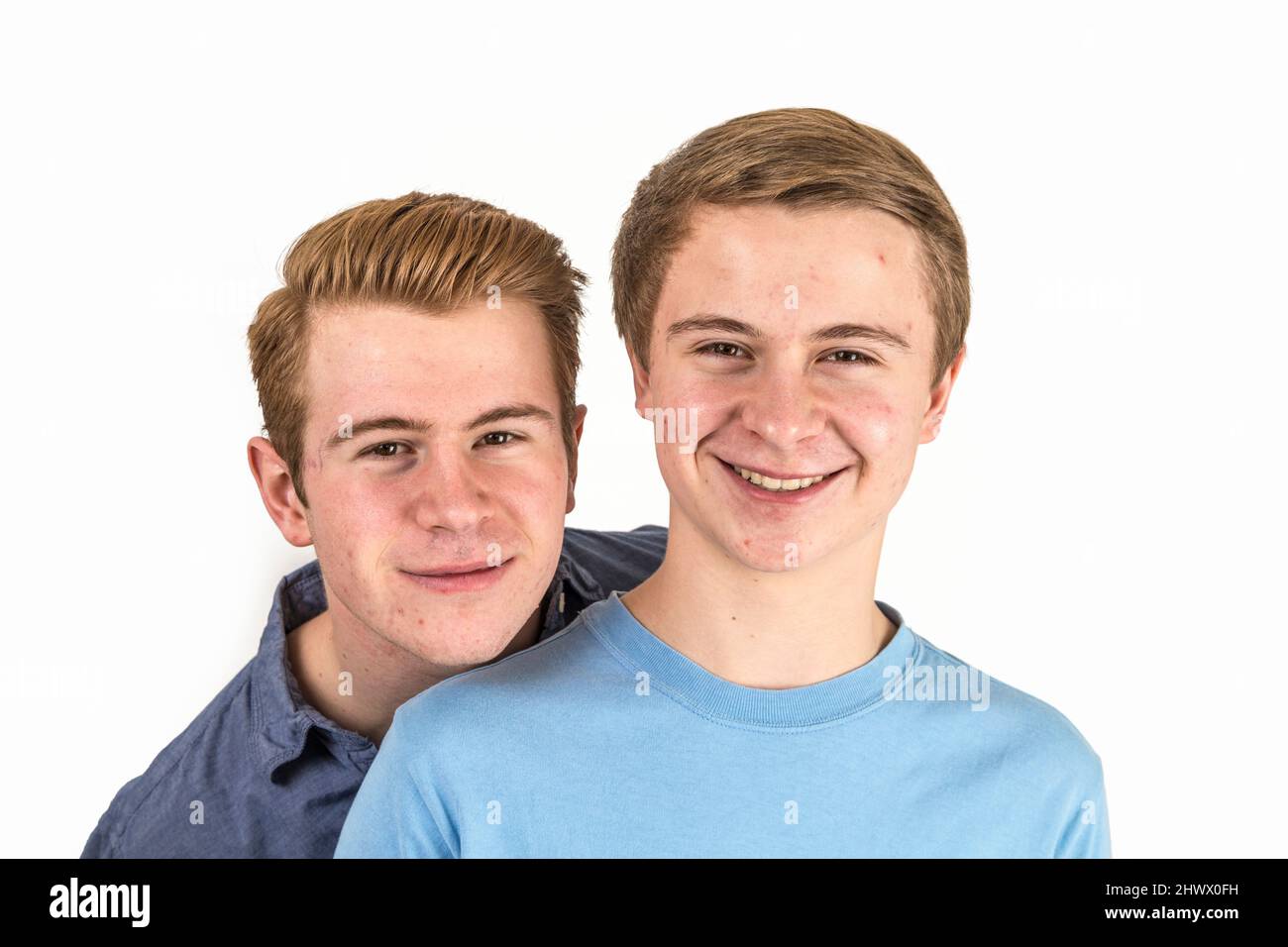 portrait of handsome brothers posing in studio Stock Photo - Alamy