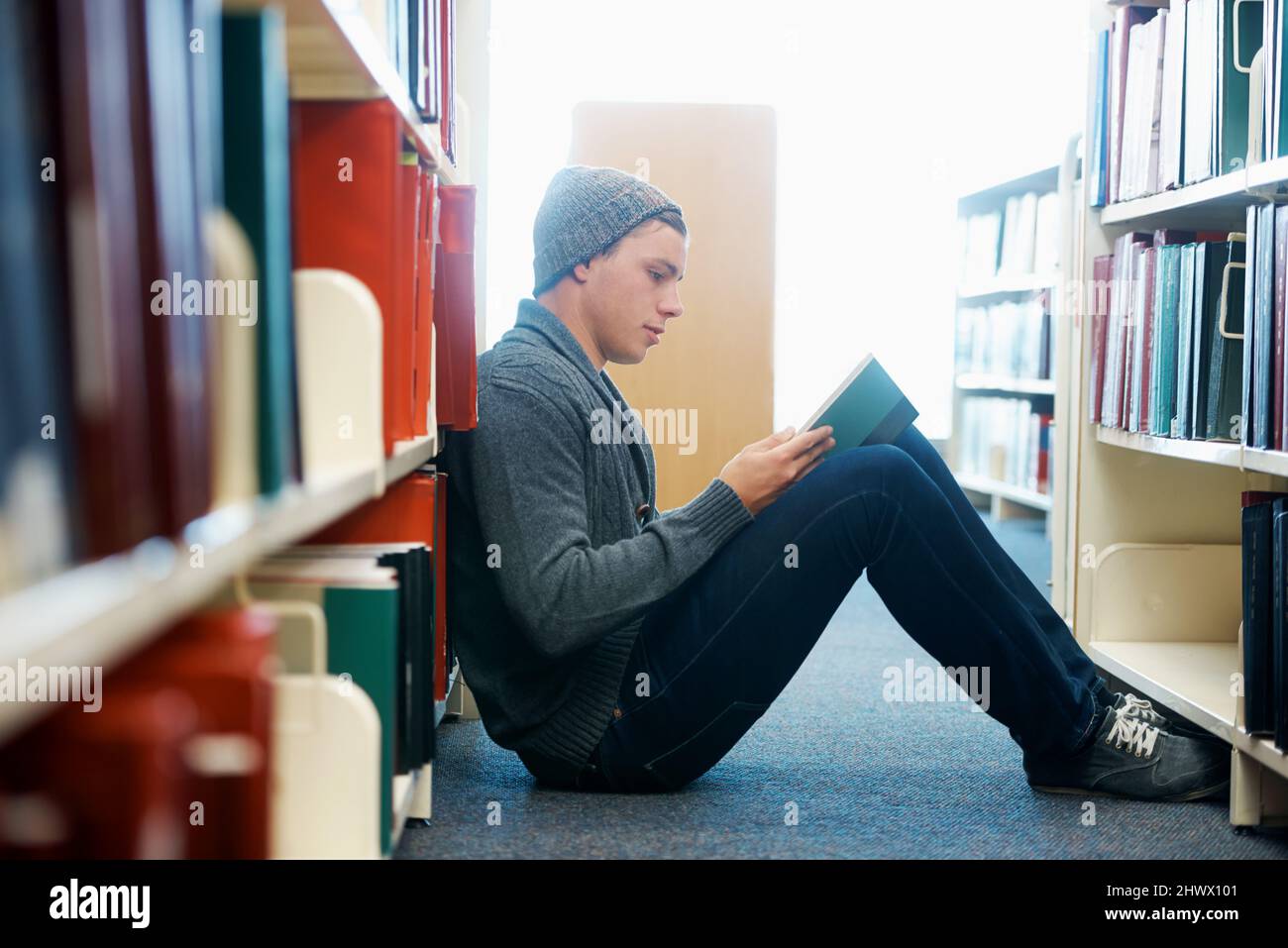Getting his study material for the year. A young man sitting on the ...