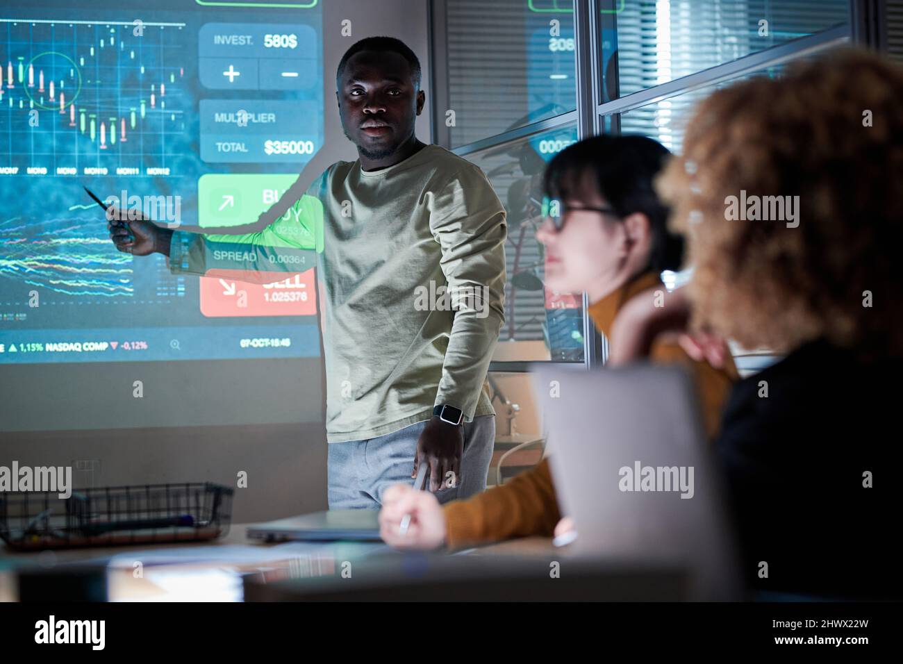 African young businessman pointing at screen with new software and ...