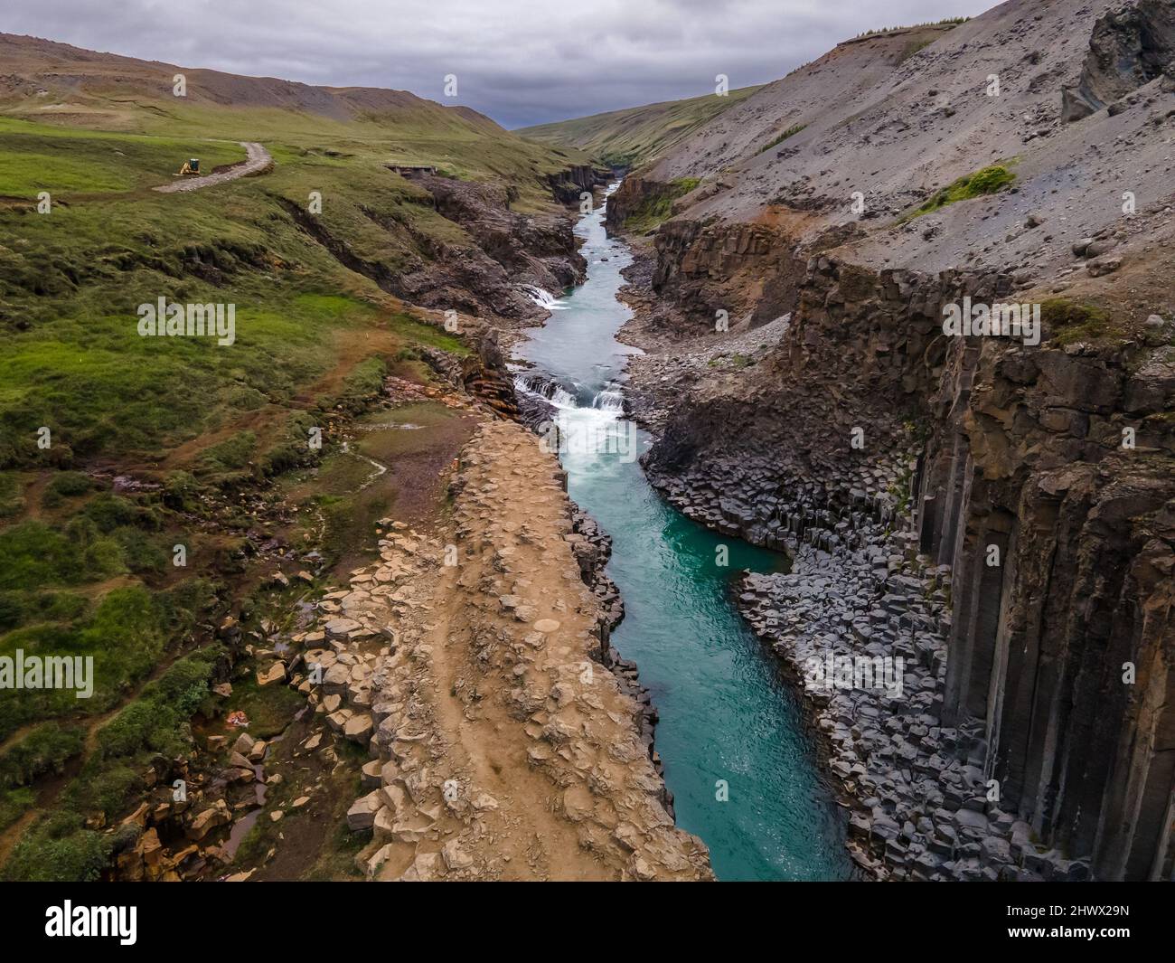 Beautiful aerial view of the studlagil canyon, and the largest number of basalt rock columns in ...