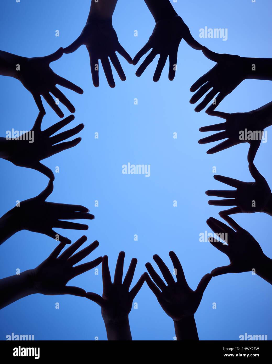 Gather your hands around. Shot of a group of hands spread out together ...