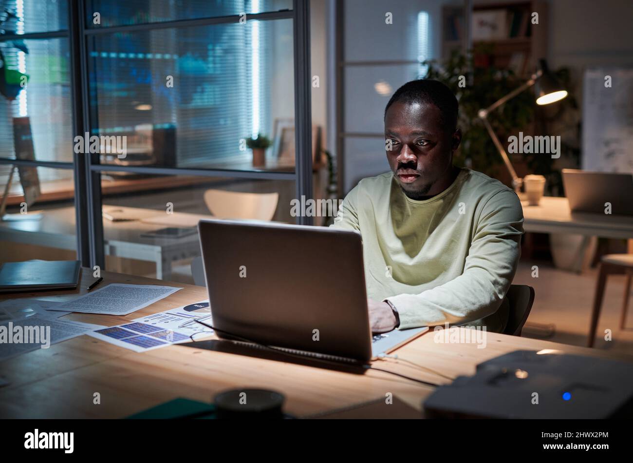 African businessman using laptop to prepare with his report sitting at ...