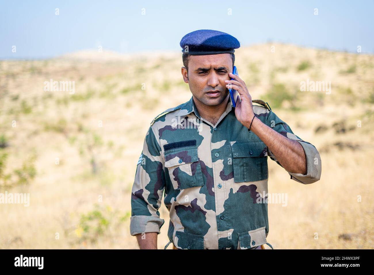 Army soldier talking on mobile phone and smiling Stock Photo - Alamy