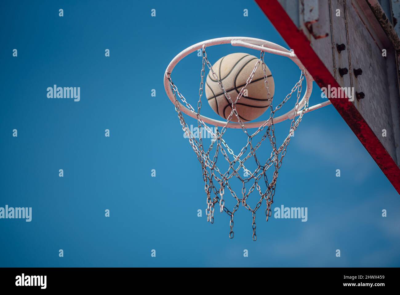 Basketball Shot Falling Through the Net with the Blue Sky background ...