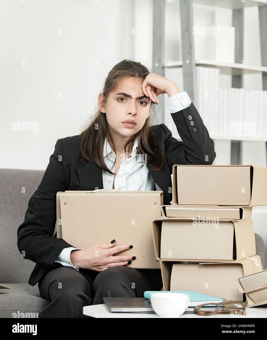 Upset business woman with many folders of documents, unhappy secretary ...