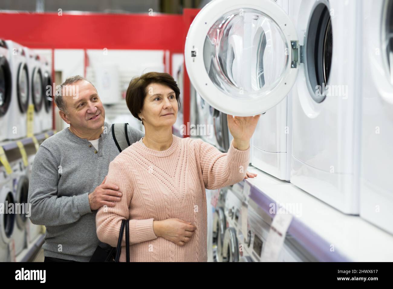 European spouses of mature age choose a washing machine Stock Photo - Alamy